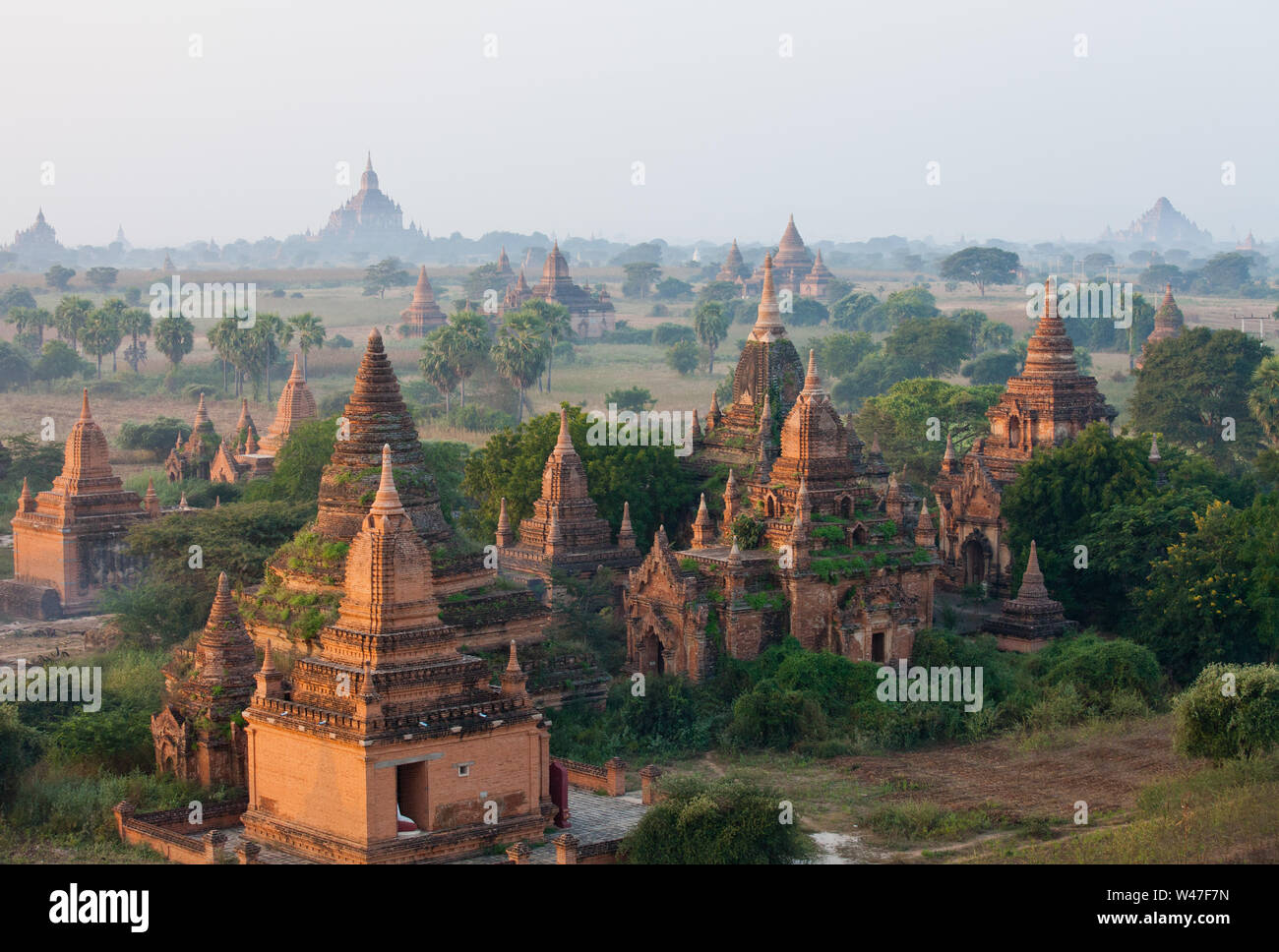 Orange sunrise landscape view with silhouettes of old ancient temples ...