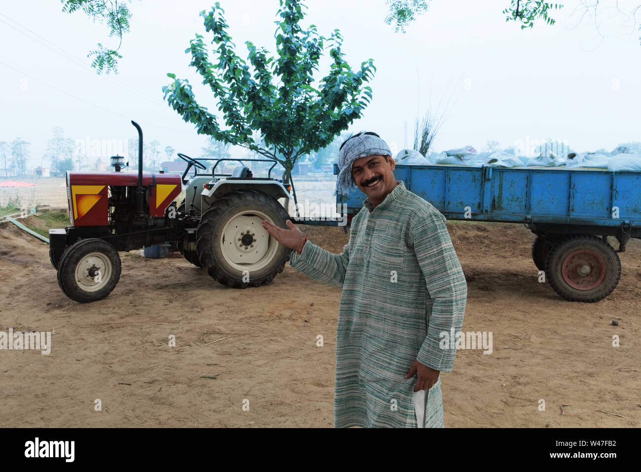 Portrait of an Indian farmer showing his tractor Stock Photo - Alamy