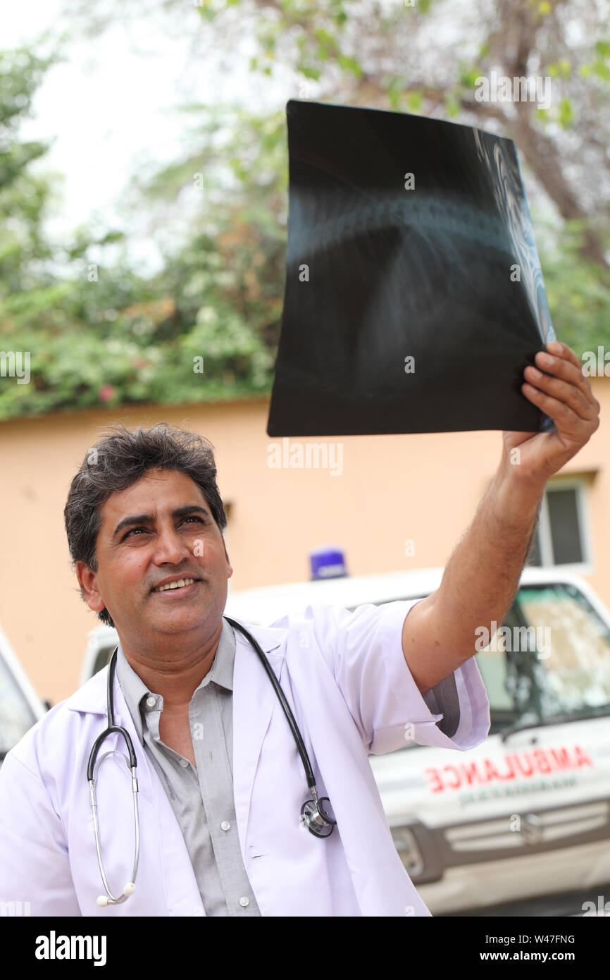 Doctor checking reports hi-res stock photography and images - Alamy