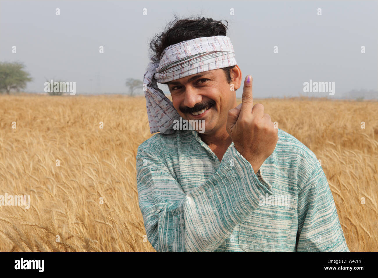 Farmer pointing upward in a field Stock Photo - Alamy