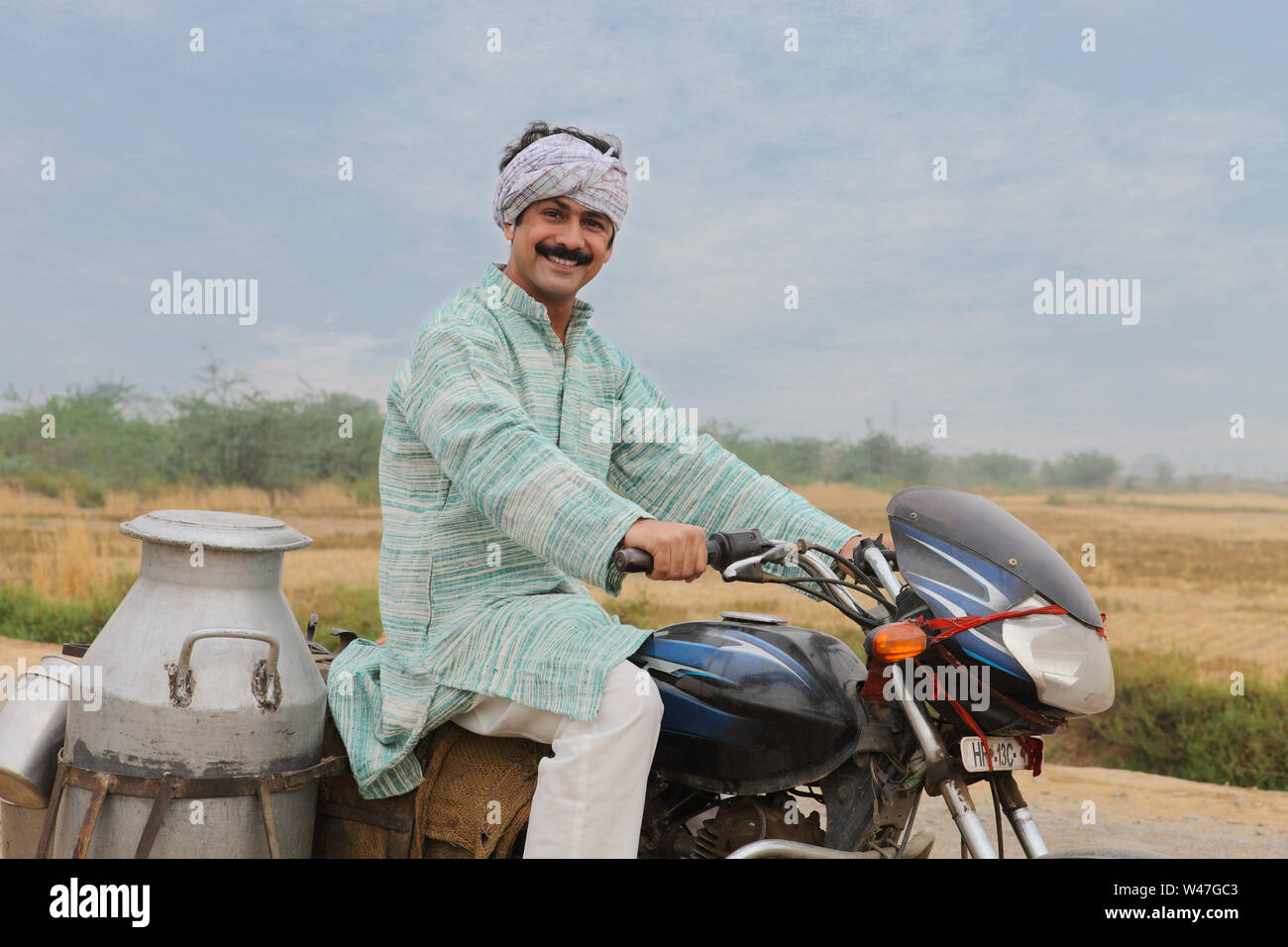Milkman delivering milk on a motorcycle Stock Photo - Alamy