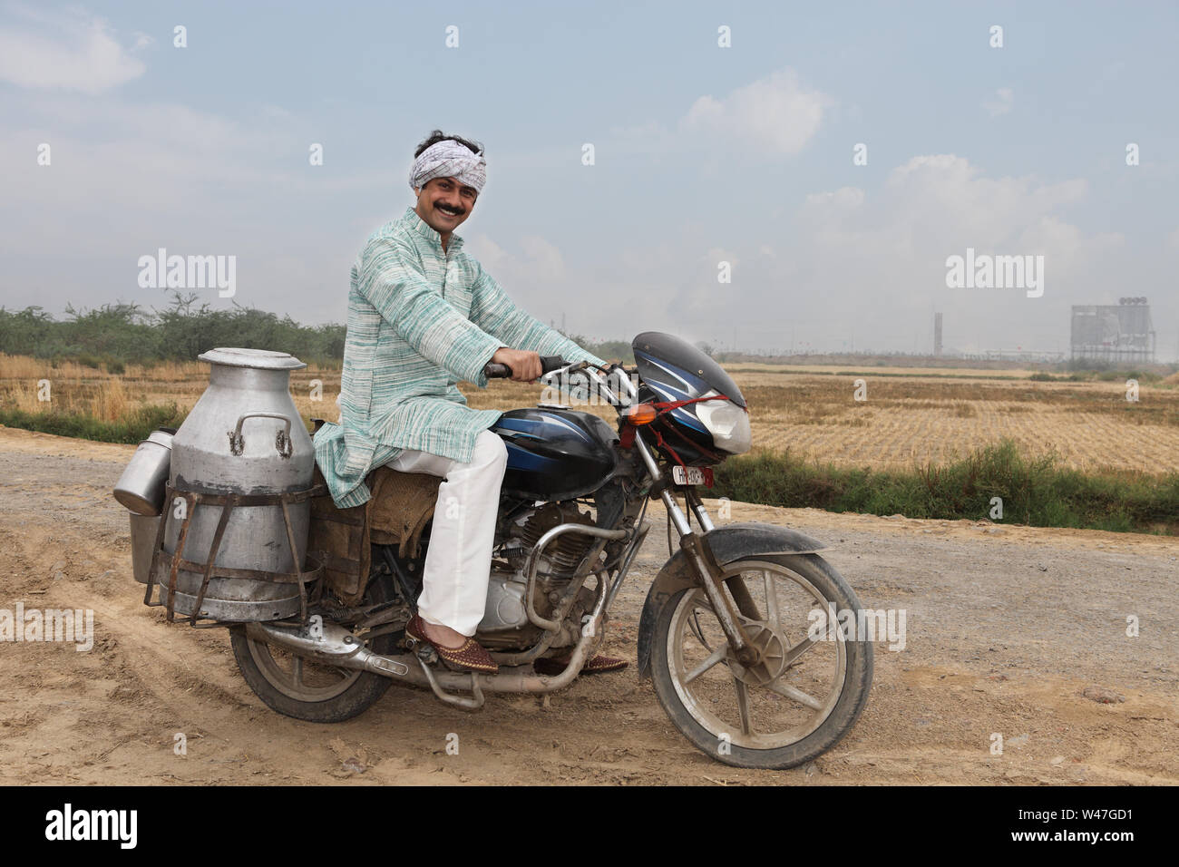 Milkman delivering milk on a motorcycle Stock Photo - Alamy