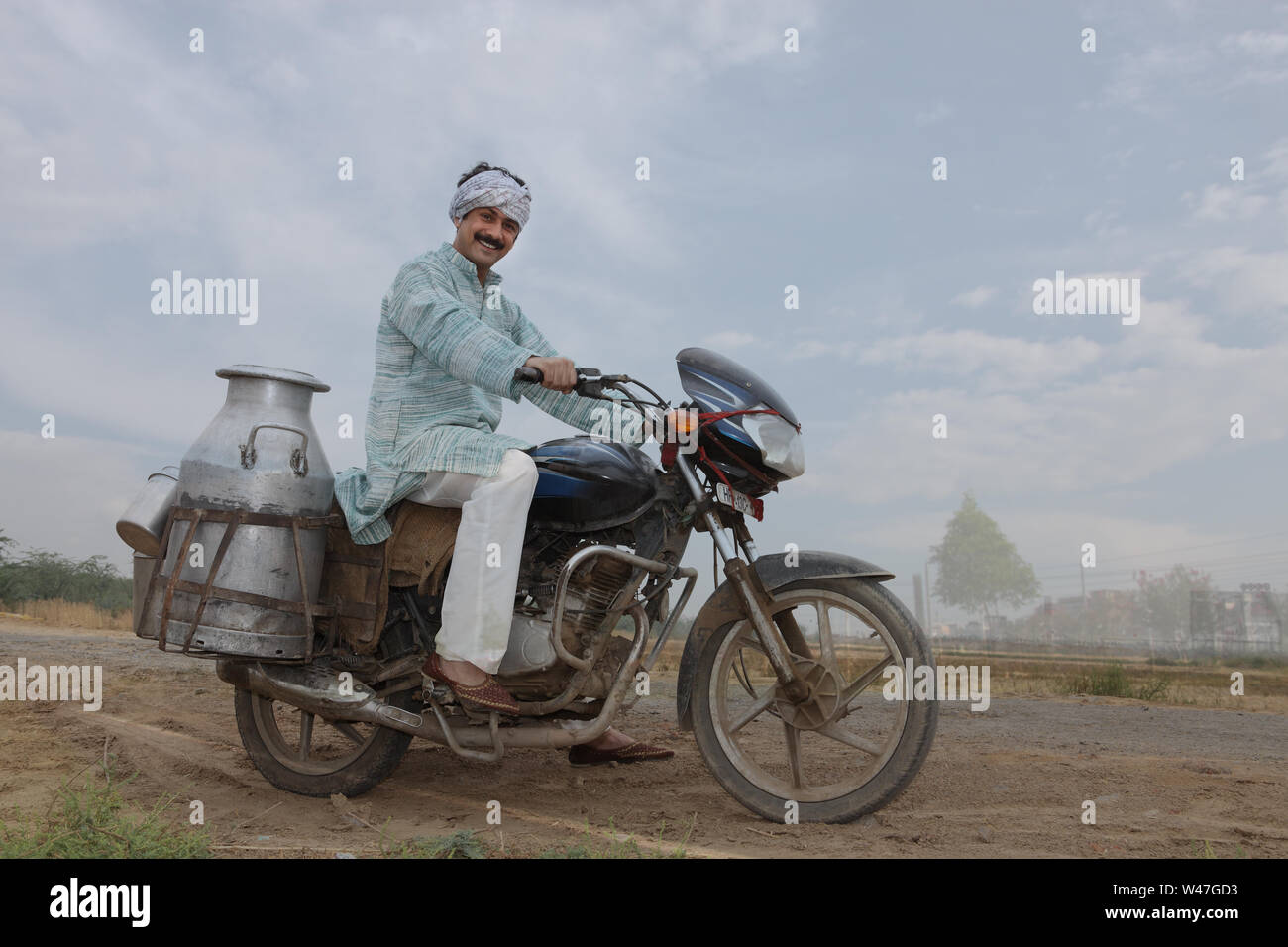 Milkman delivering milk on a motorcycle Stock Photo - Alamy