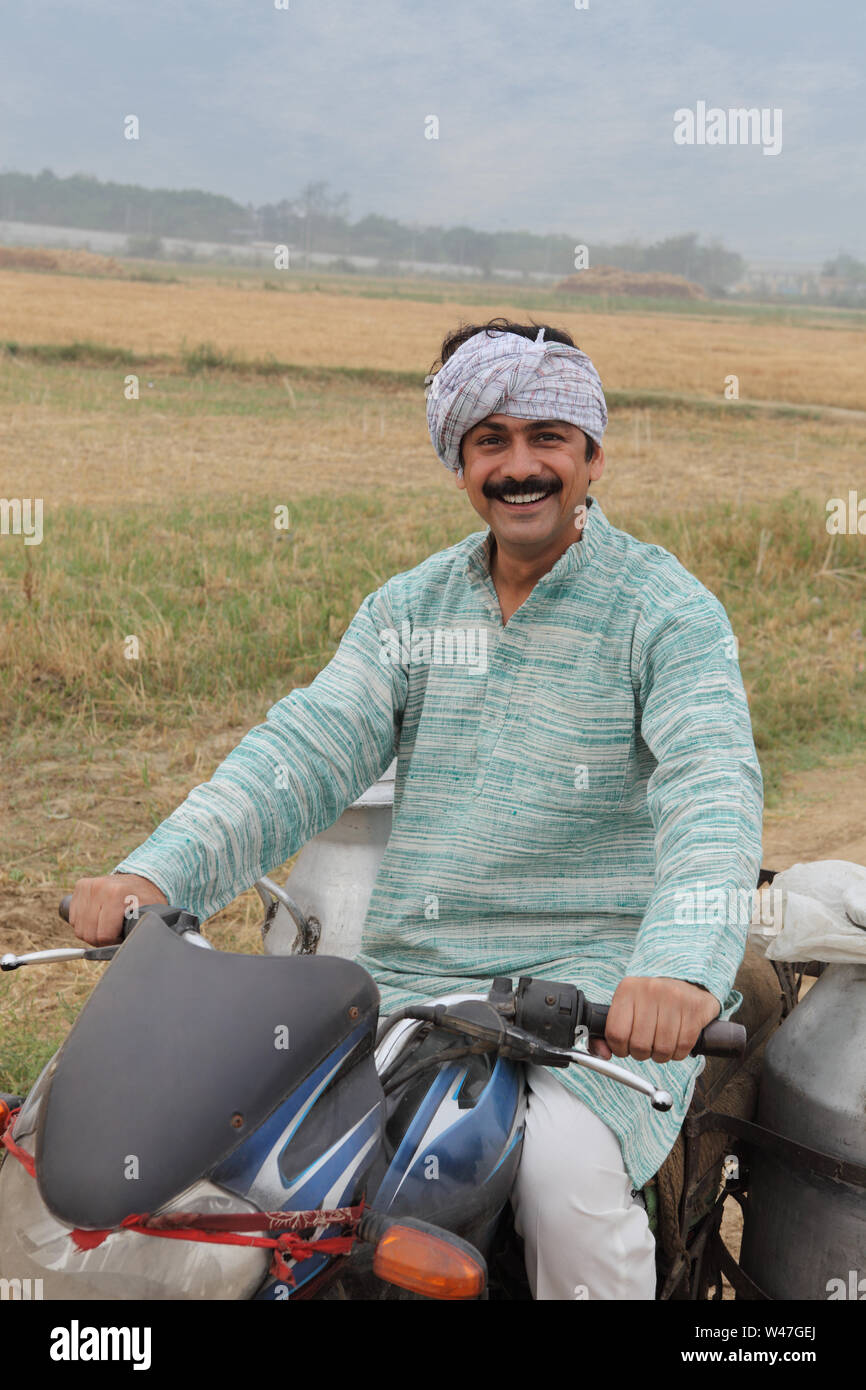 Milkman delivering milk on a motorcycle Stock Photo - Alamy