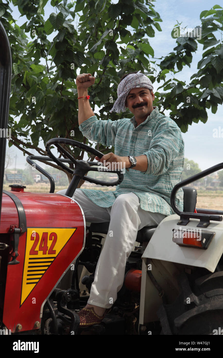 Indian farmer driving tractor hi-res stock photography and images - Alamy