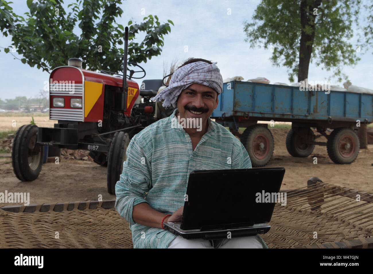 Farmer using a laptop Stock Photo - Alamy
