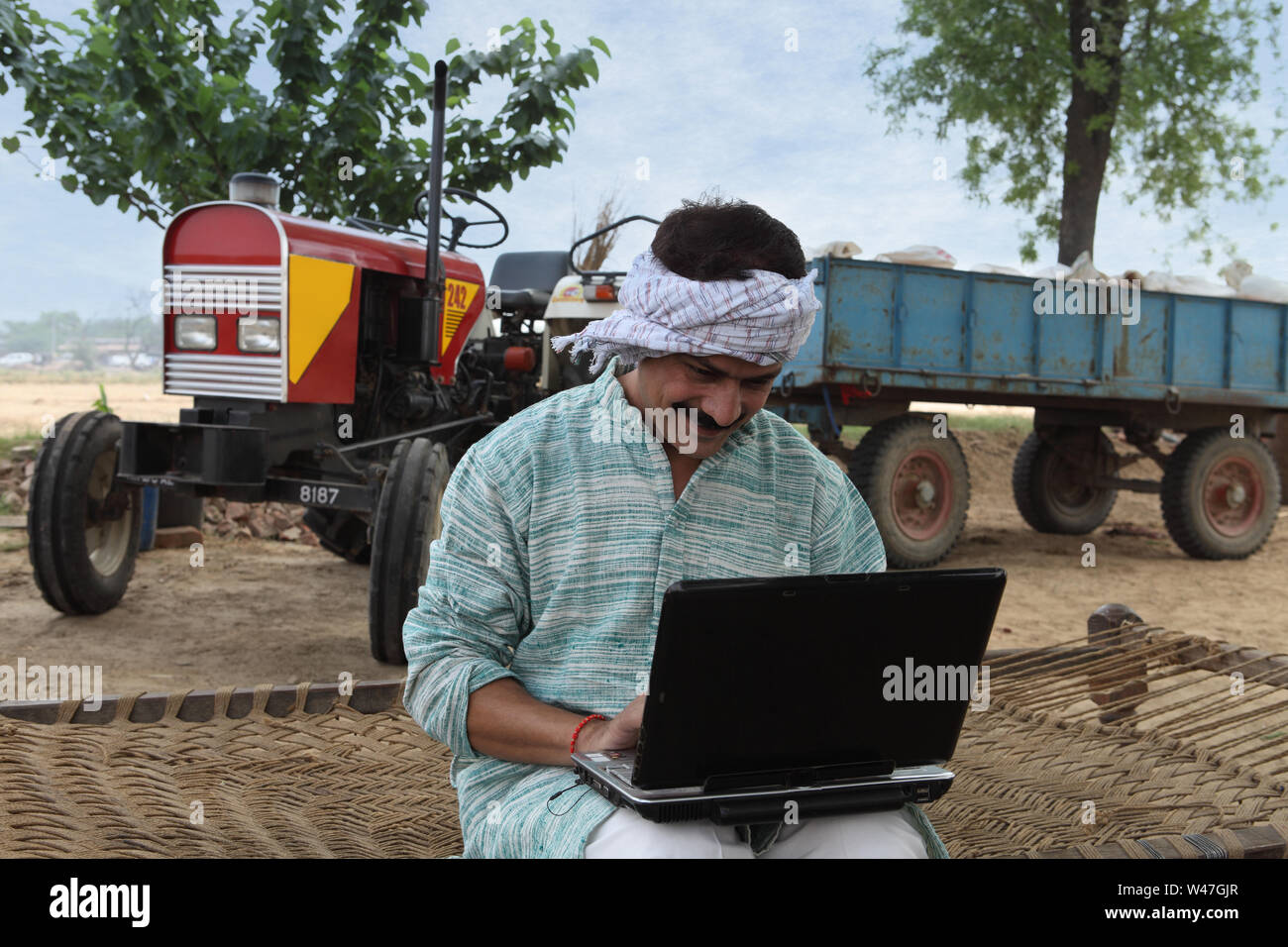 Farmer using a laptop Stock Photo - Alamy