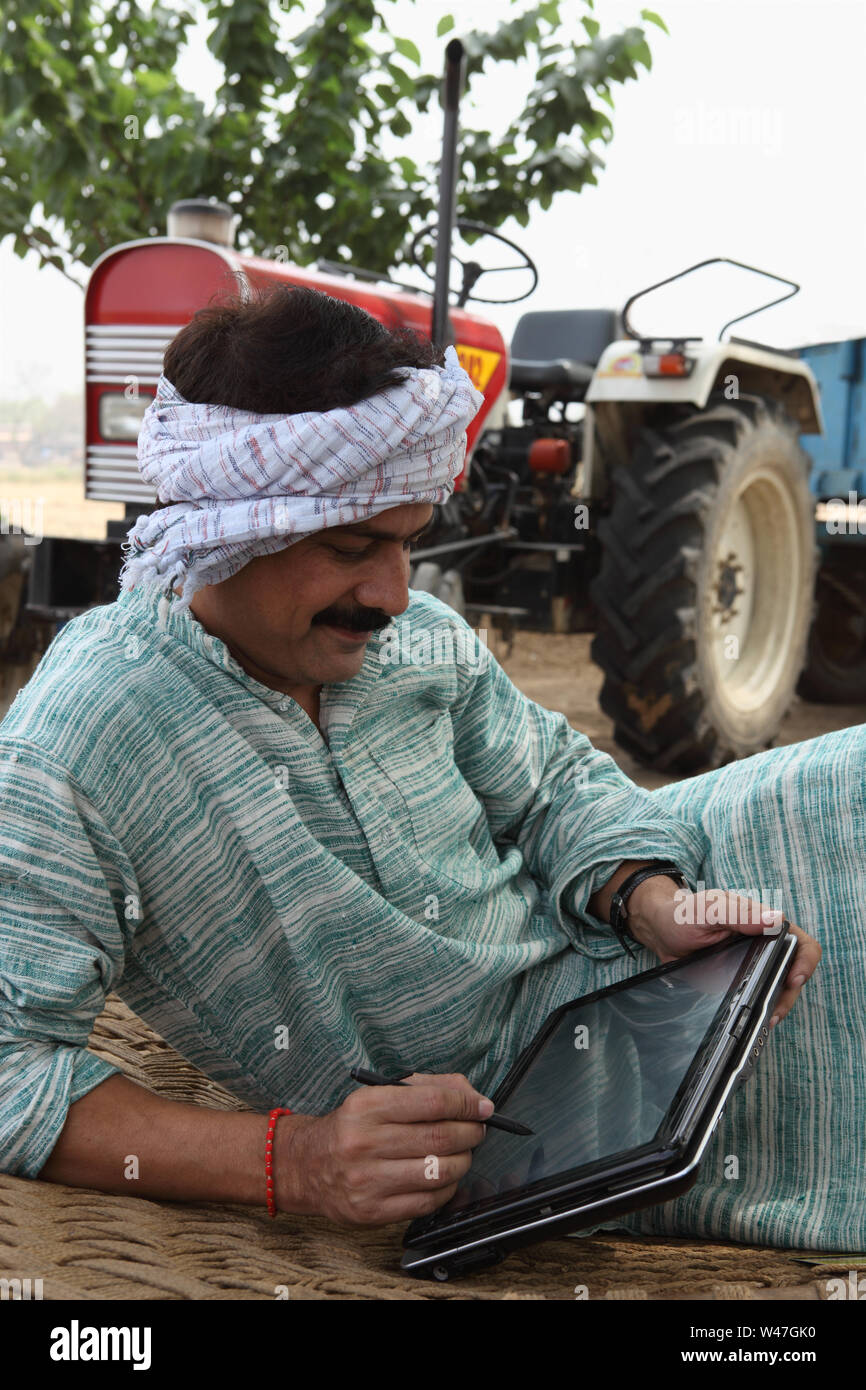 Farmer working tablet online communication hi-res stock photography and ...
