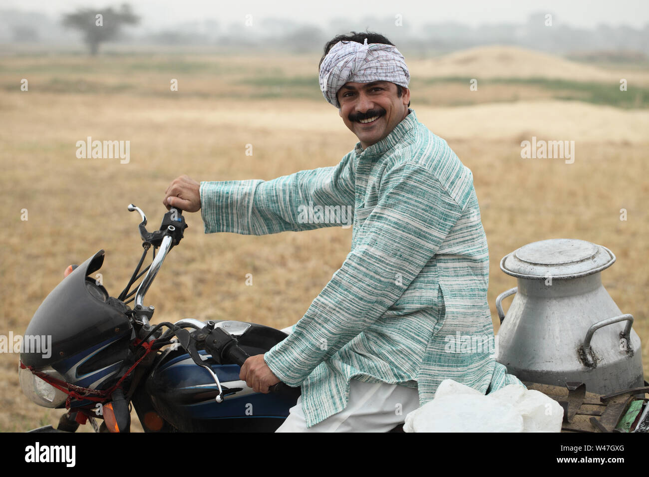 Milkman delivering milk on a motorcycle Stock Photo - Alamy