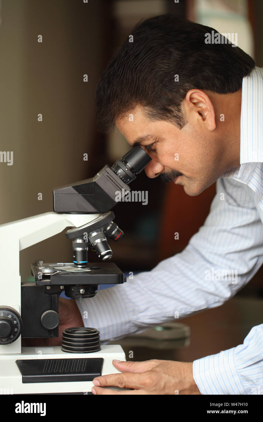 Indian doctor with microscope hi-res stock photography and images - Alamy
