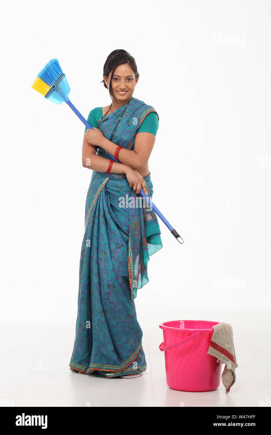Woman holding bucket and smiling Stock Photo - Alamy