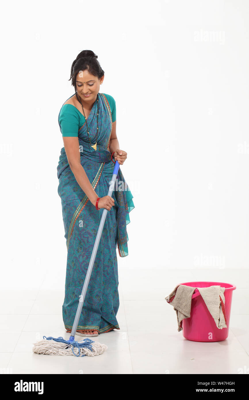 Woman wiping floor and smiling Stock Photo - Alamy