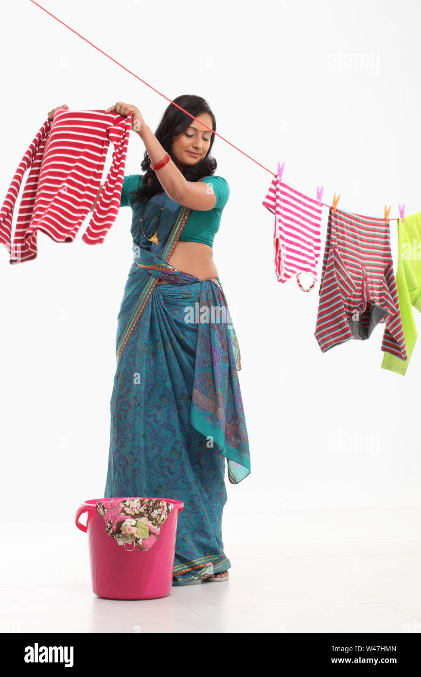 Woman drying clothes on washing line Stock Photo - Alamy