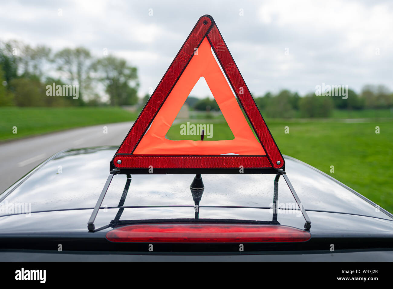 warning triangle stands on a car roof Stock Photo - Alamy