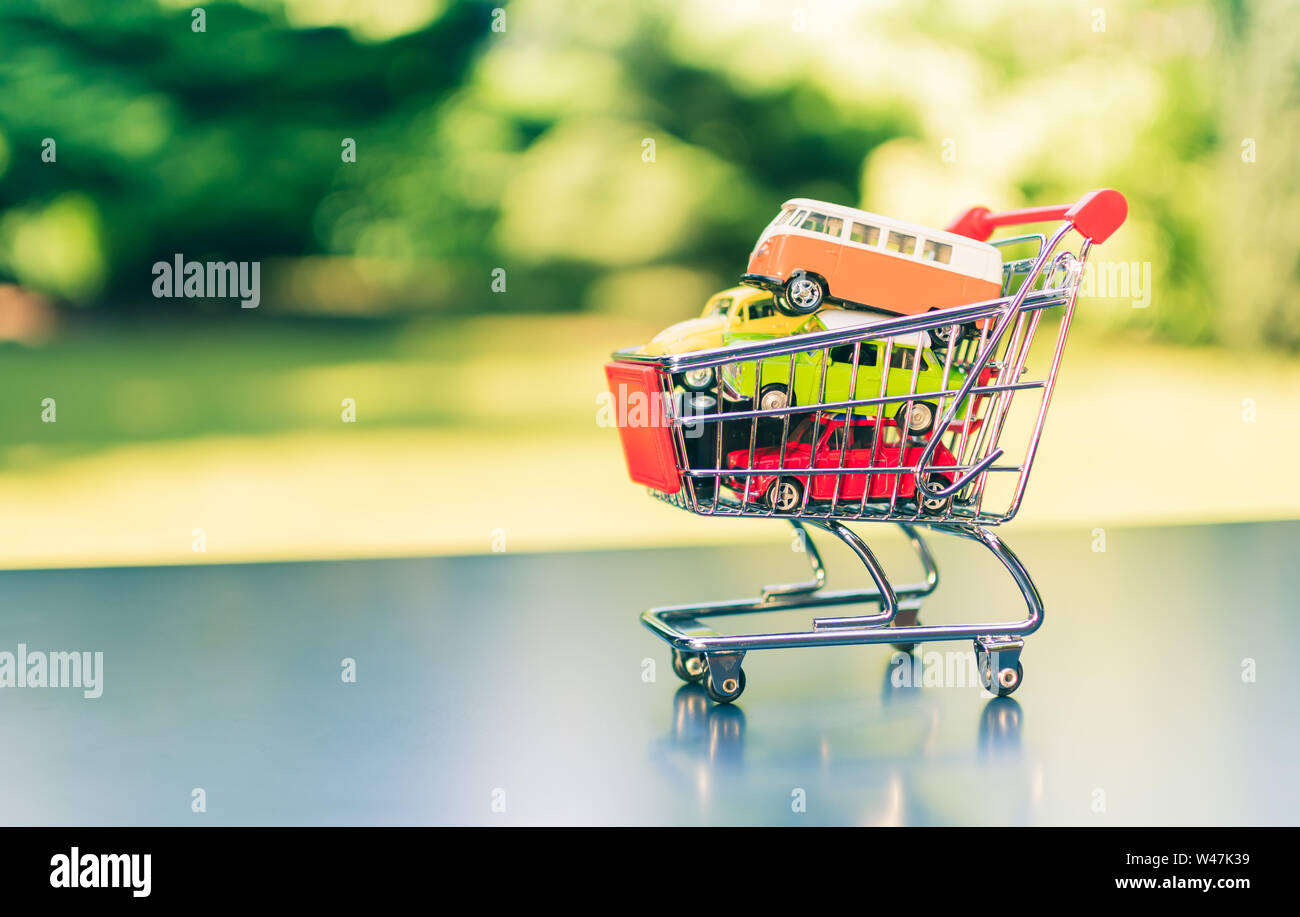 A miniature shopping cart full of cars Stock Photo - Alamy