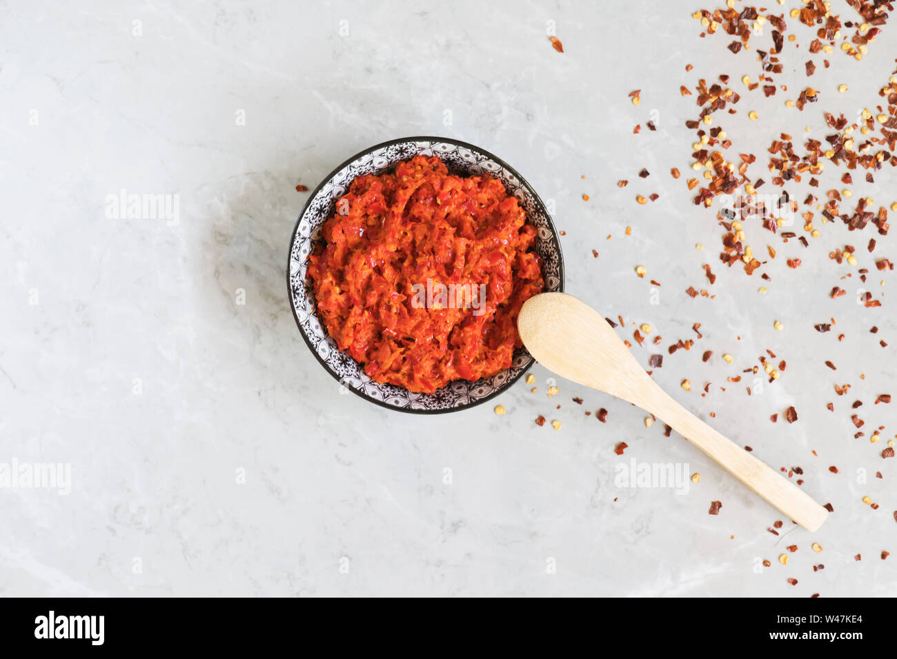 Traditional Maghrebi hot chili pepper sauce harissa on a grey marble ...