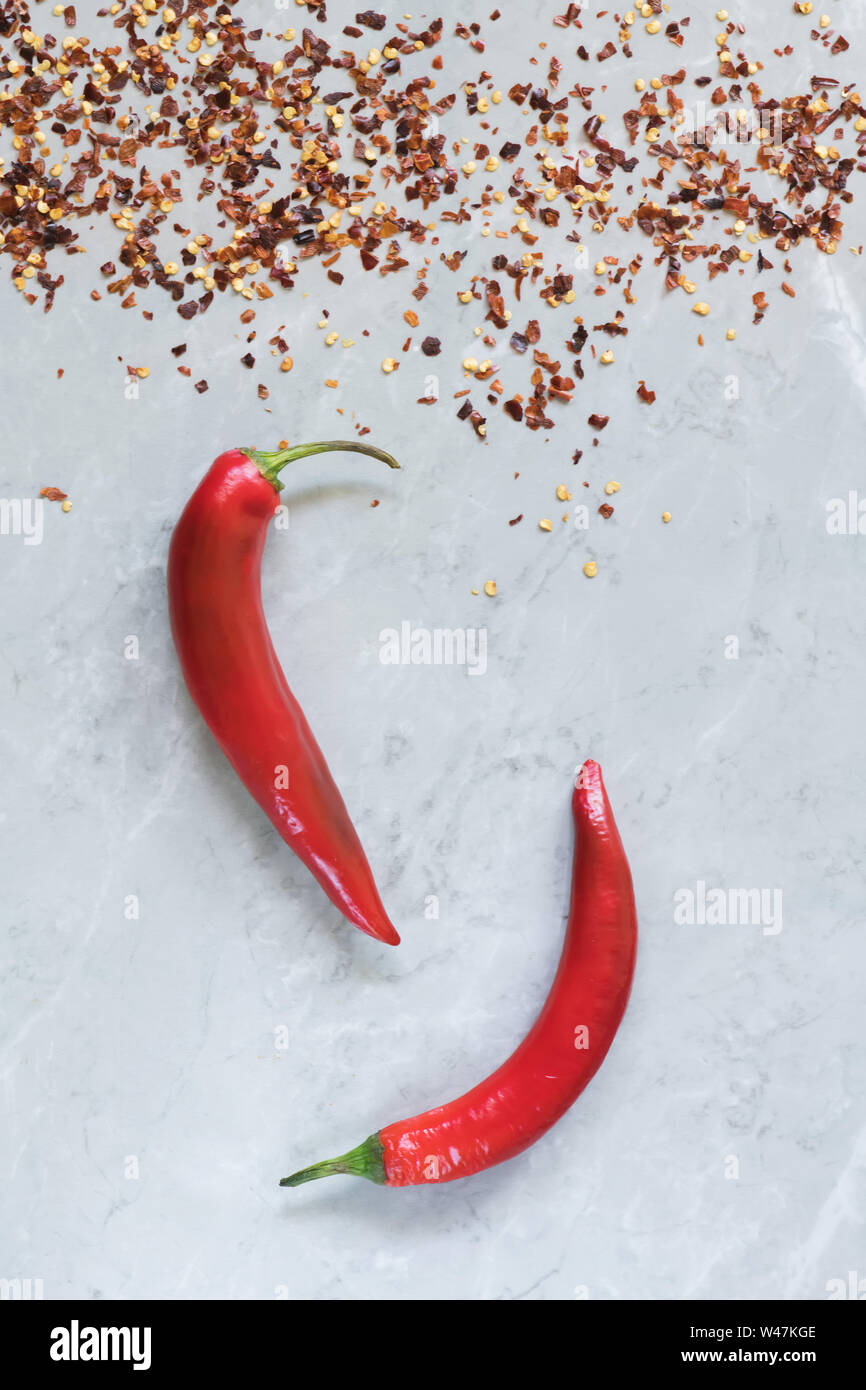 Two hot chili peppers on grey marble background, use for arabic sauce ...