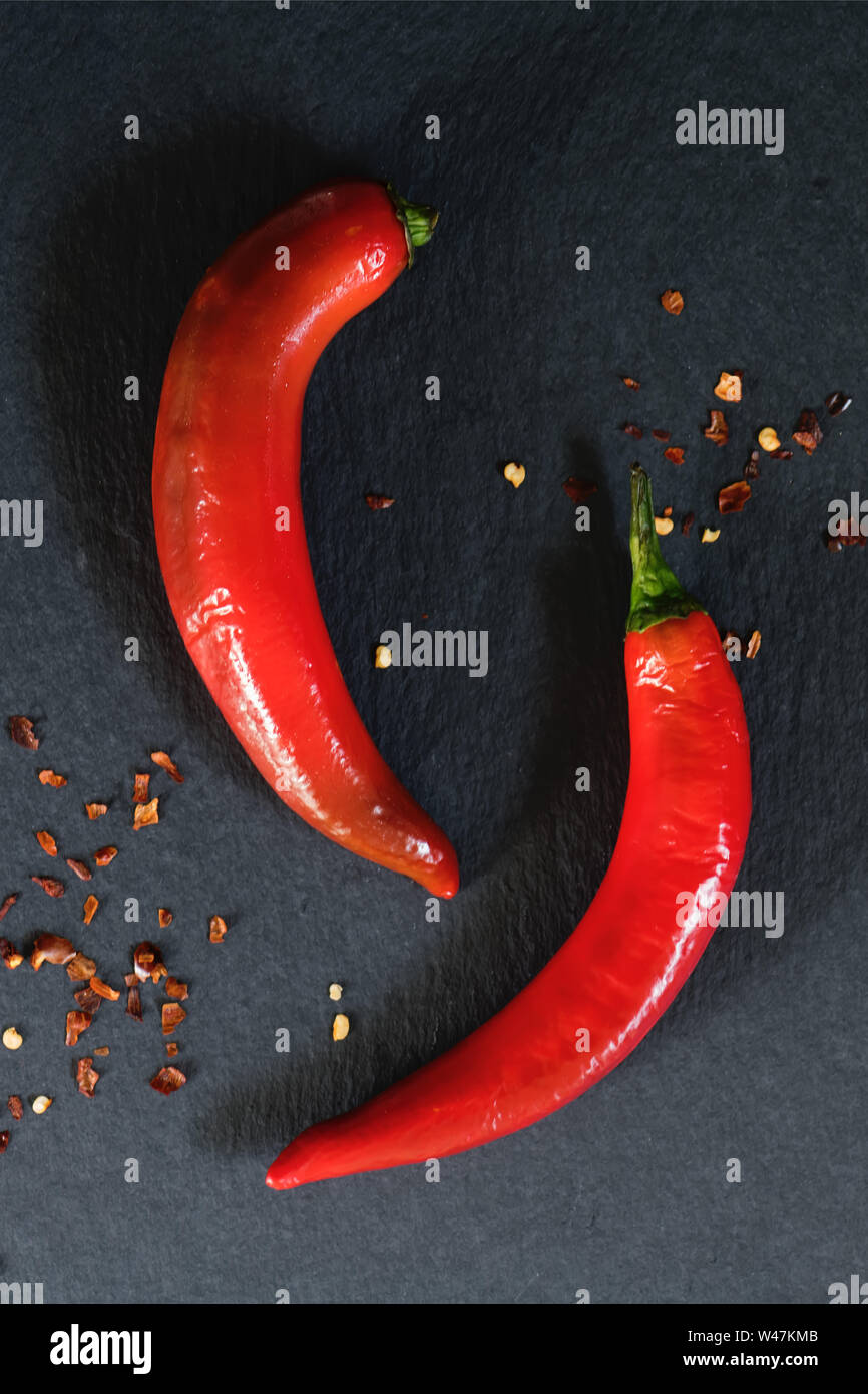 Two hot chili peppers on grey marble background. use for arabic sauce ...