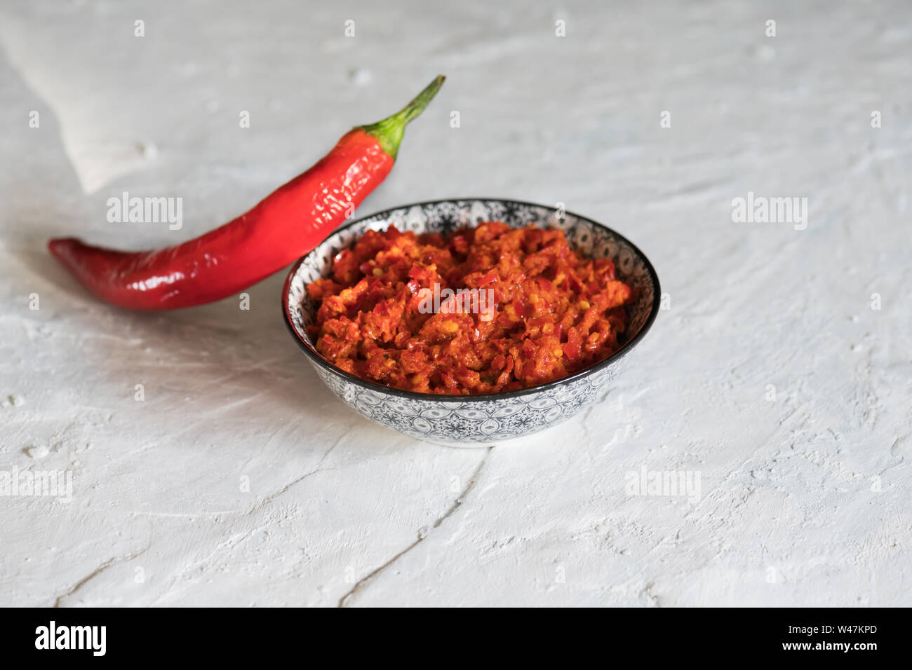 Traditional Maghrebi hot chili pepper sauce harissa on a grey ...