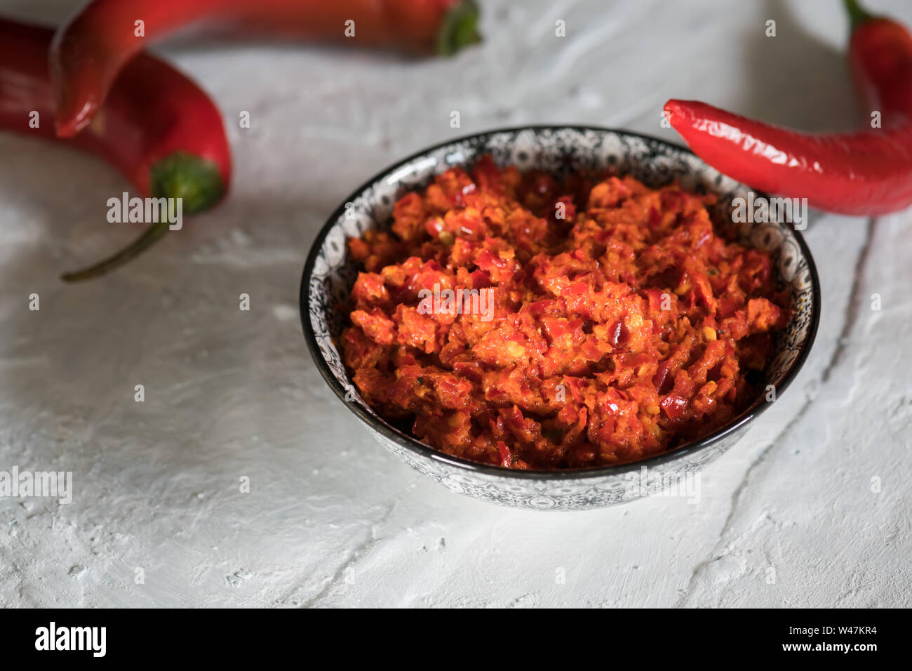 Traditional Maghrebi hot chili pepper sauce harissa on a grey ...