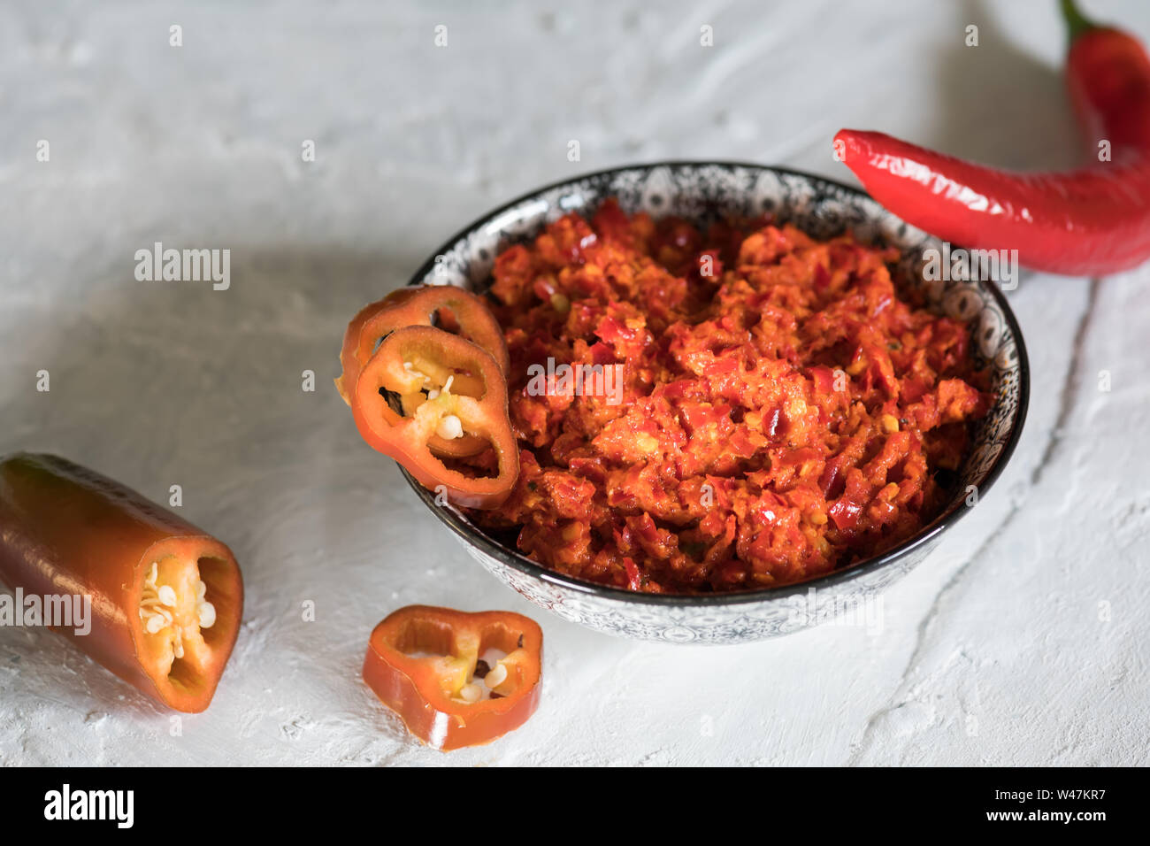 Traditional Maghrebi hot chili pepper sauce harissa on a grey ...