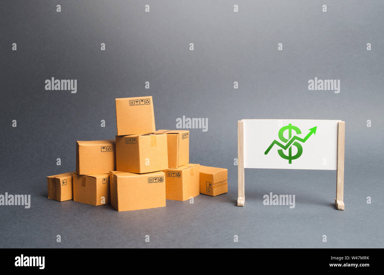 A pile of cardboard boxes and whiteboard with dollar sign and green up ...