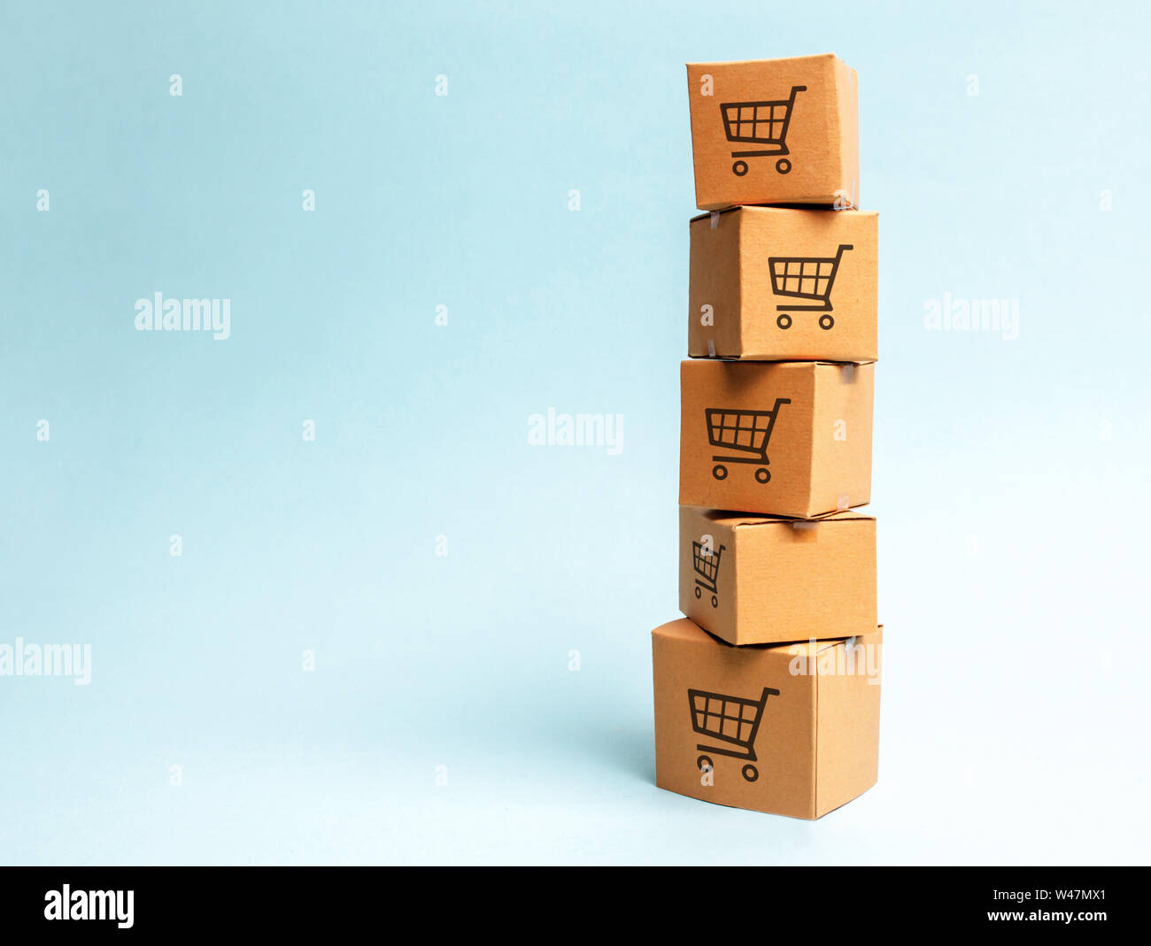 Tower of cardboard boxes with pattern of shopping carts on a blue ...