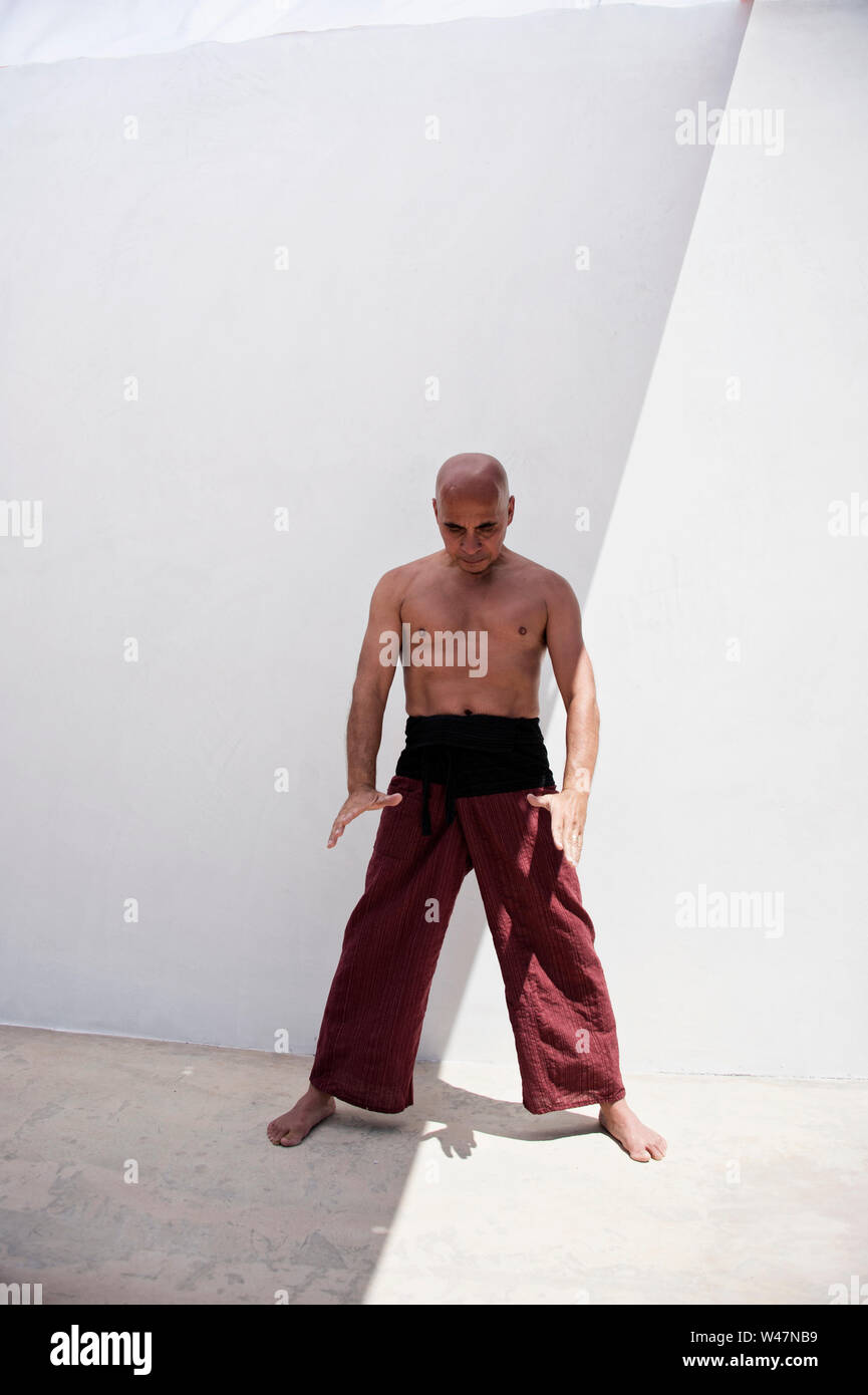 Martial Arts man practicing mindfulness exercises to harmonize body ...