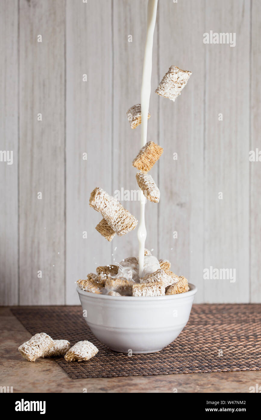 Wheat Cereal and Milk Splash in a White Bowl Stock Photo - Alamy