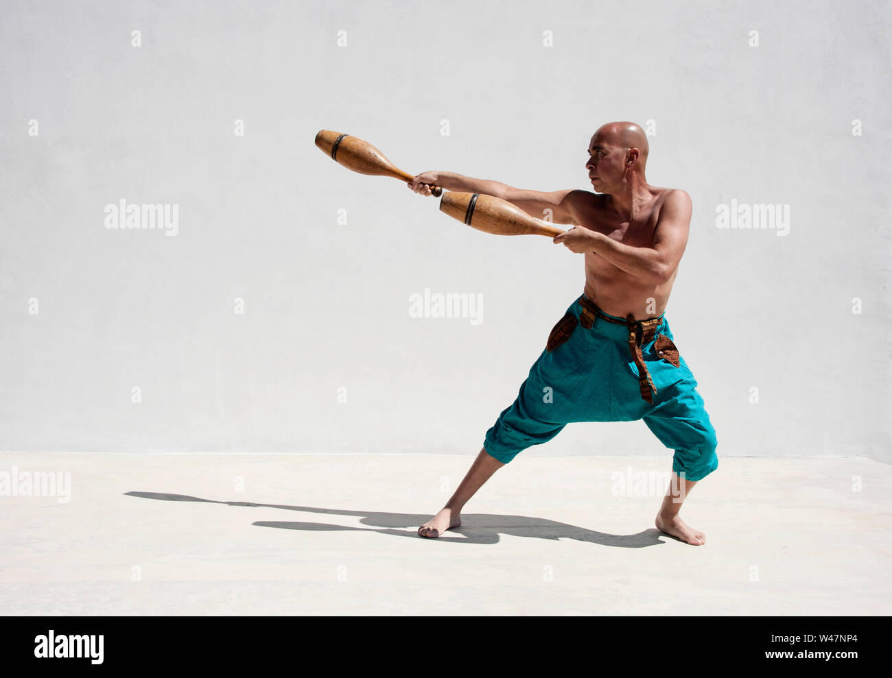 Man practicing with classic Indian Clubs a traditional exercise from ...