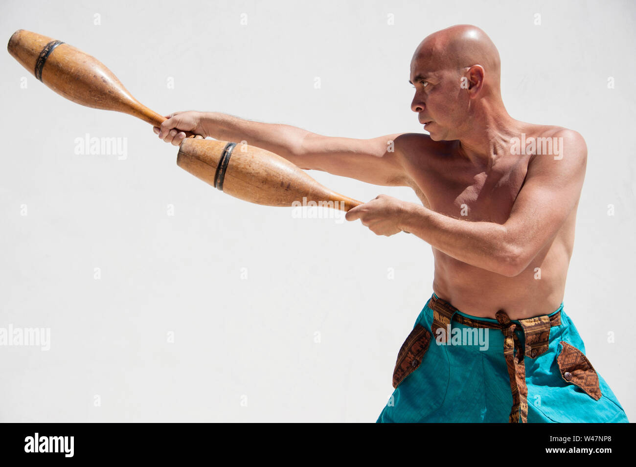 Man practicing with classic Indian Clubs a traditional exercise from ...