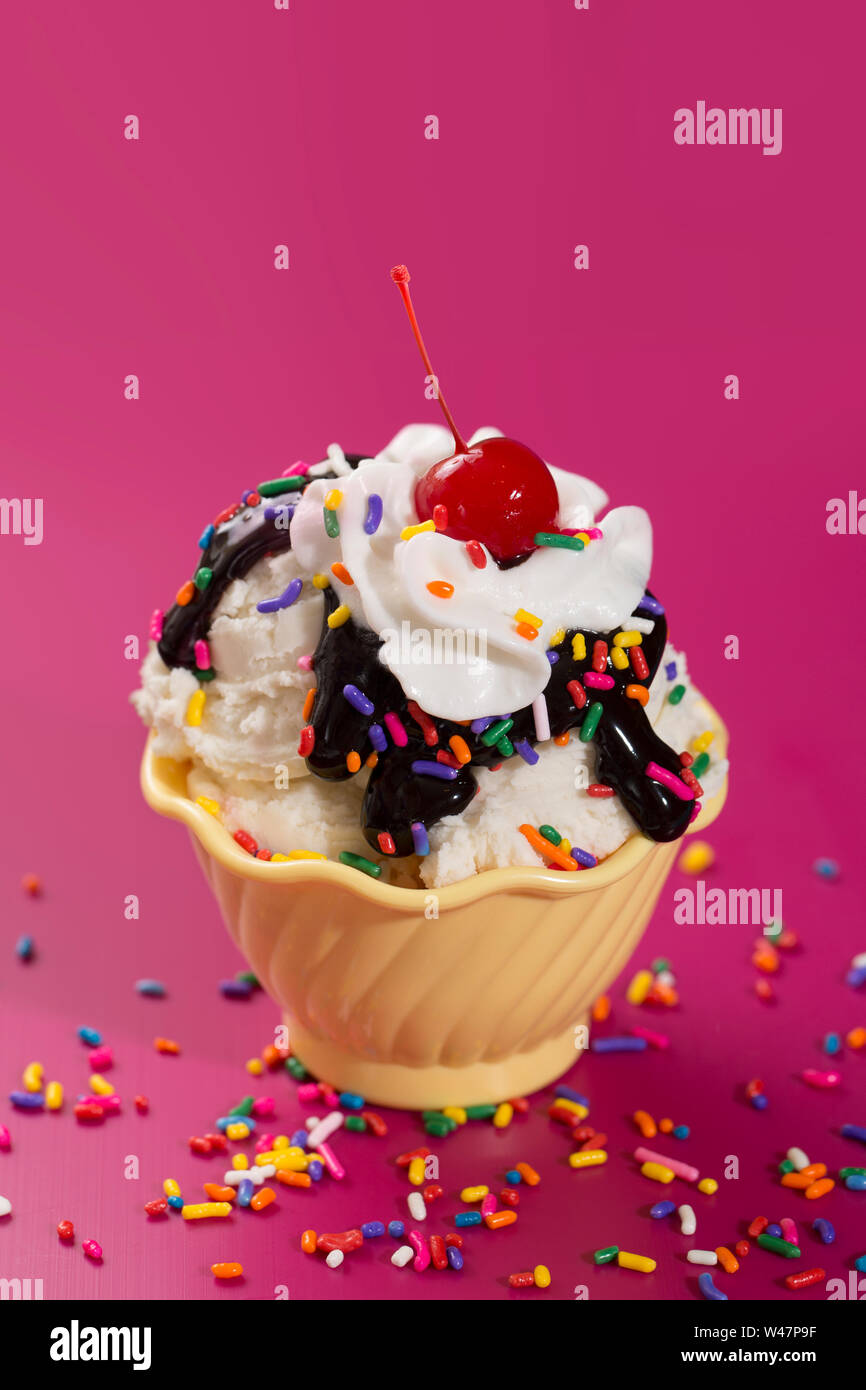 Vanilla Ice Cream Sundae in a yellow bowl on a pink background Stock ...