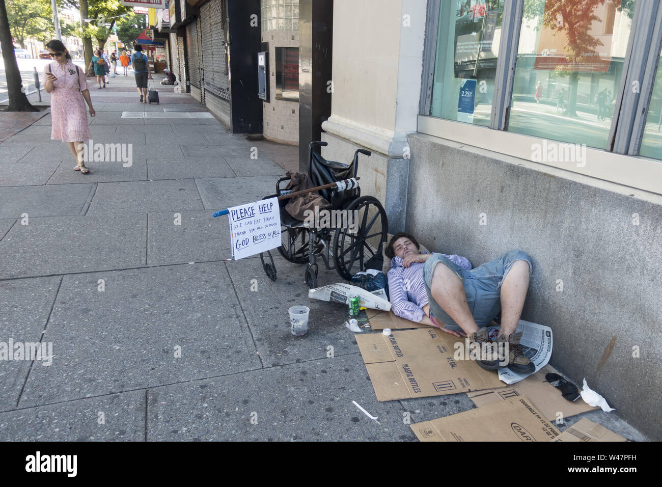 Disabled homeless man sleeps along the sidewalk on Kings Highway in the ...