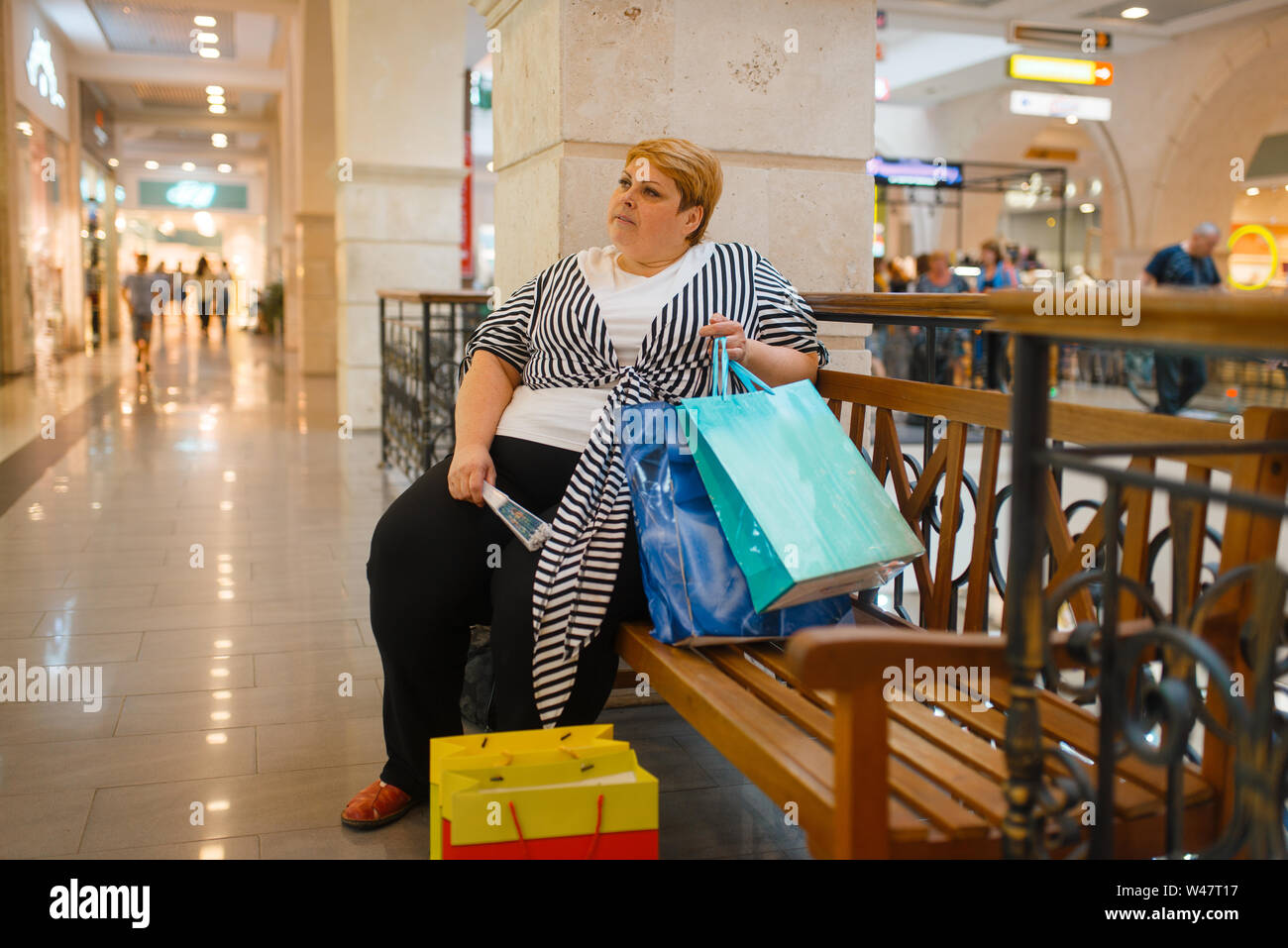 Obese woman sitting in mall hi-res stock photography and images - Alamy