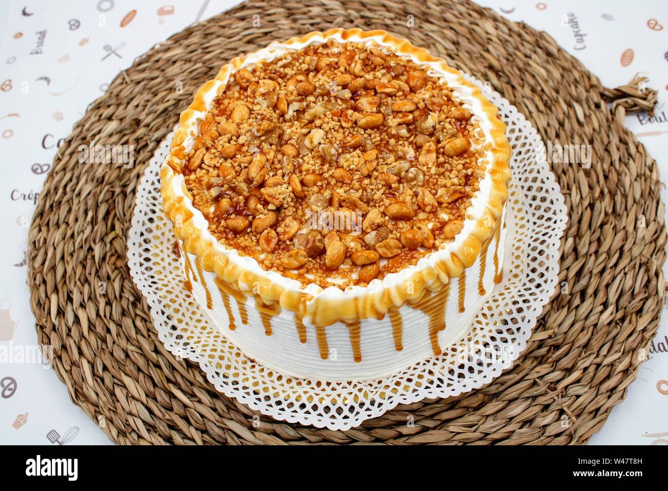 Cream cake with caramel syrup decoration and crispy peanuts Stock Photo ...