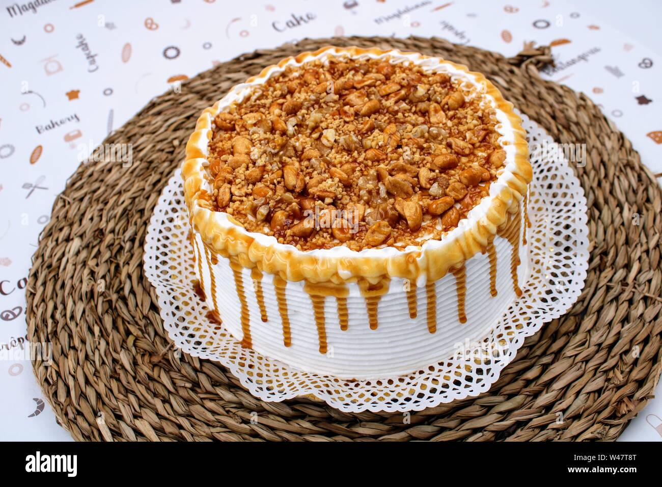 Cream cake with caramel syrup decoration and crispy peanuts Stock Photo ...