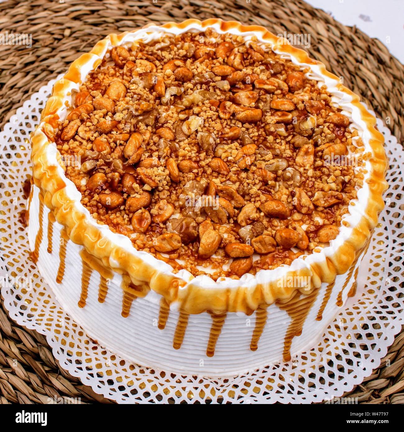 Cream cake with caramel syrup decoration and crispy peanuts Stock Photo ...