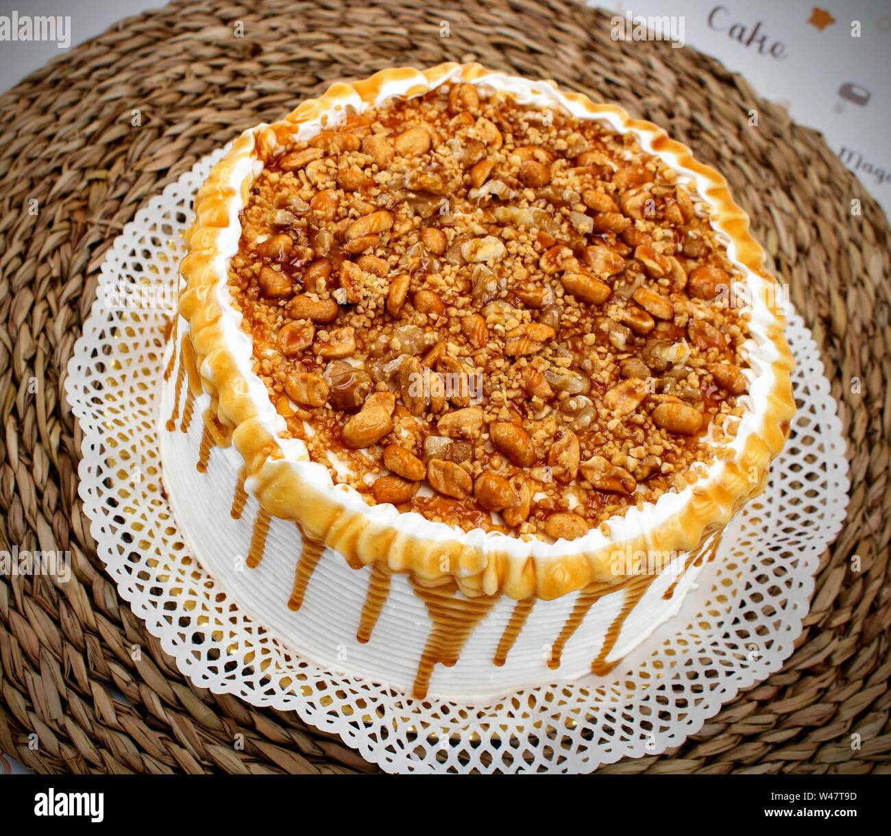 Cream cake with caramel syrup decoration and crispy peanuts Stock Photo ...