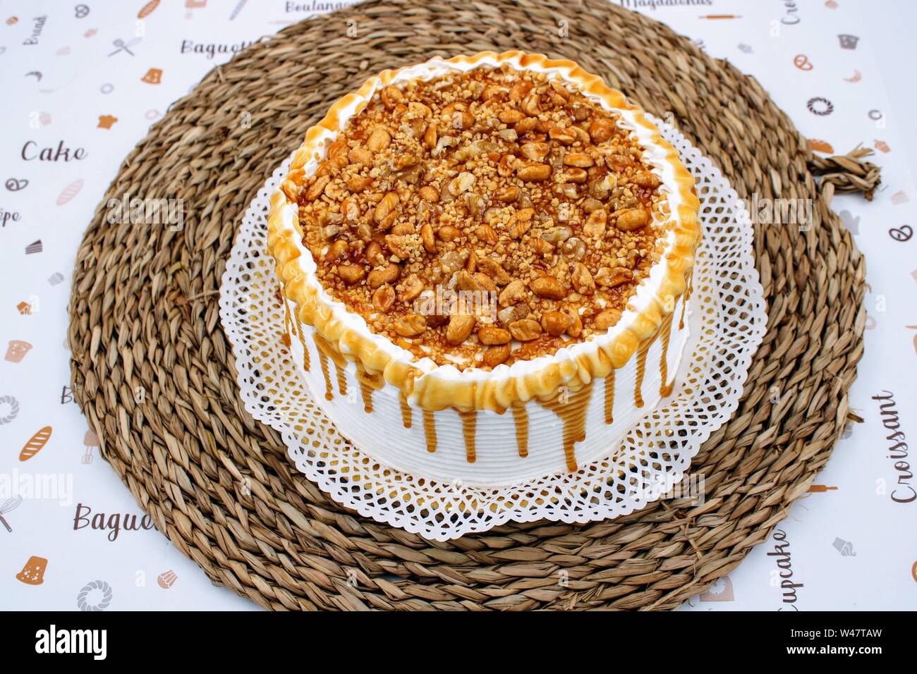 Cream cake with caramel syrup decoration and crispy peanuts Stock Photo ...