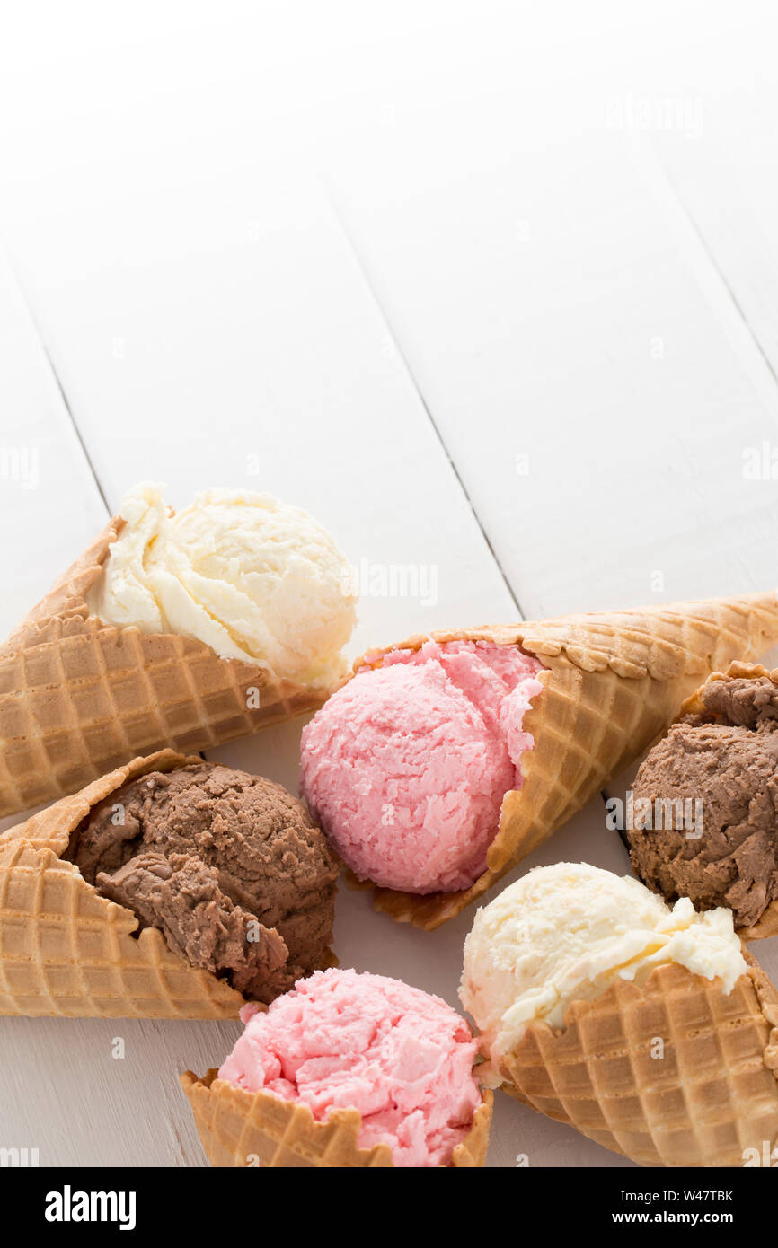 Strawberry, Vanilla, and Chocolate Ice Cream in Waffle Cones Stock ...