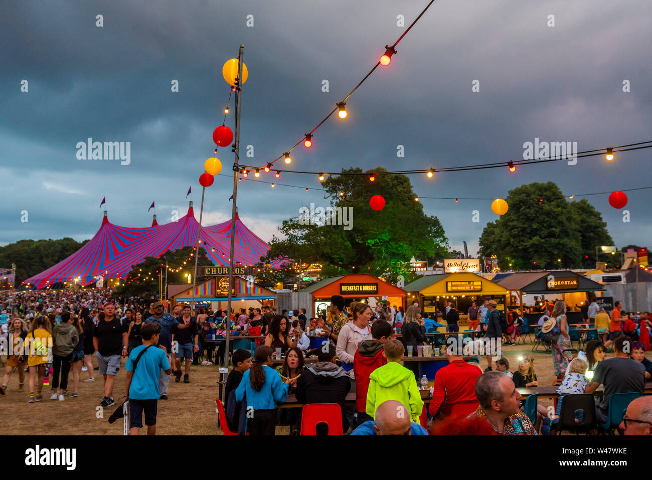 Henham Park, Suffolk, 20 July 2019. Dusk falls over the arena with a ...