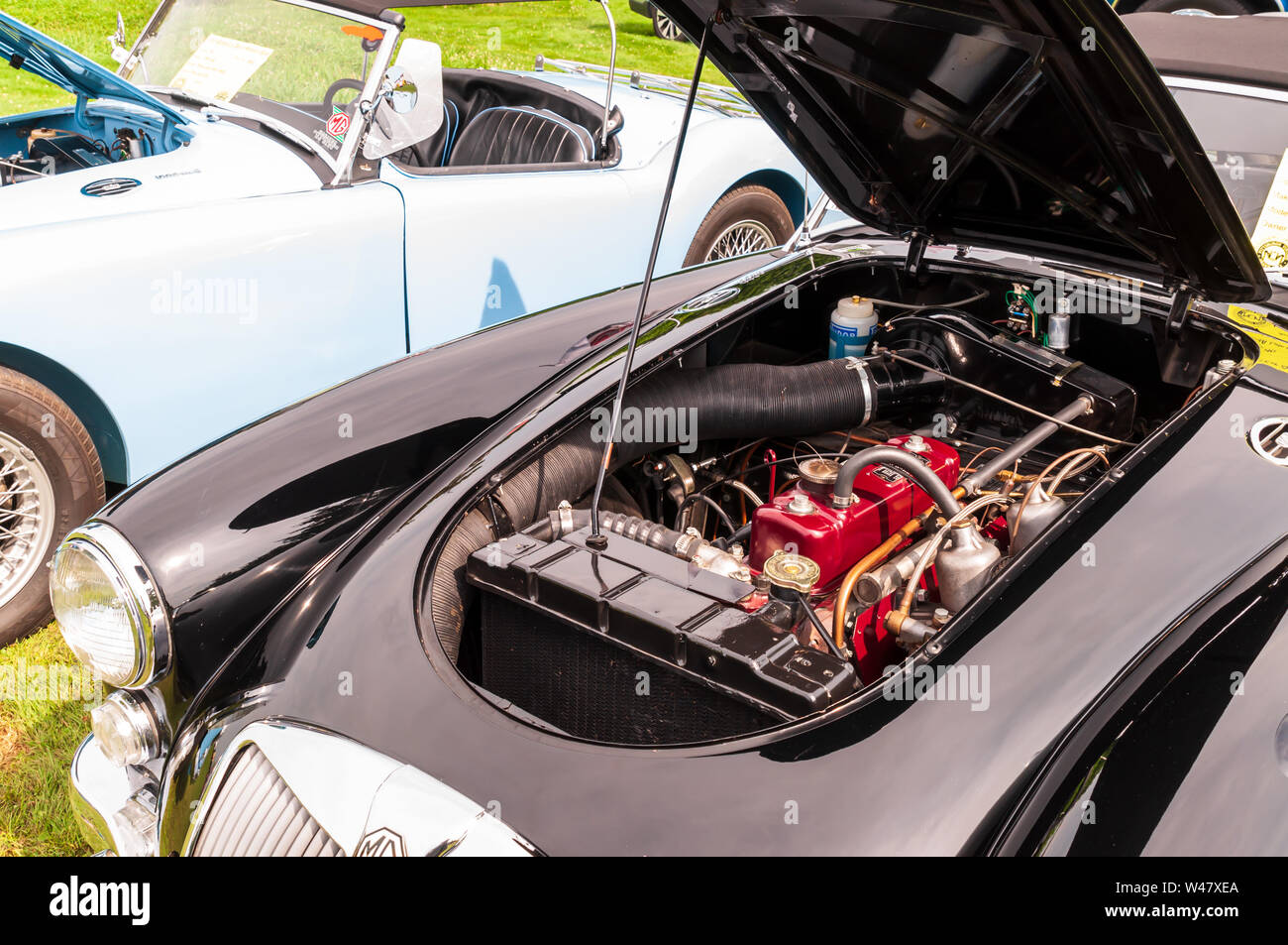 The engine compartment of an old black MG at the Pittsburgh Gran Prix ...