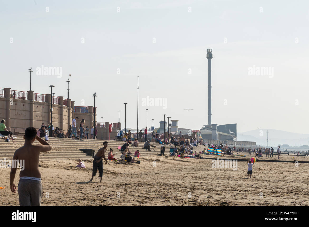 RHYL, NORTH WALES - APRIL 21, 2019: People enjoying sunny day at the ...