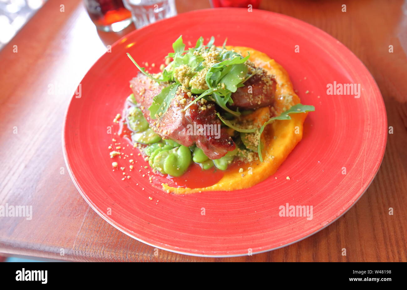 French duck meat and pees source dish France Stock Photo - Alamy