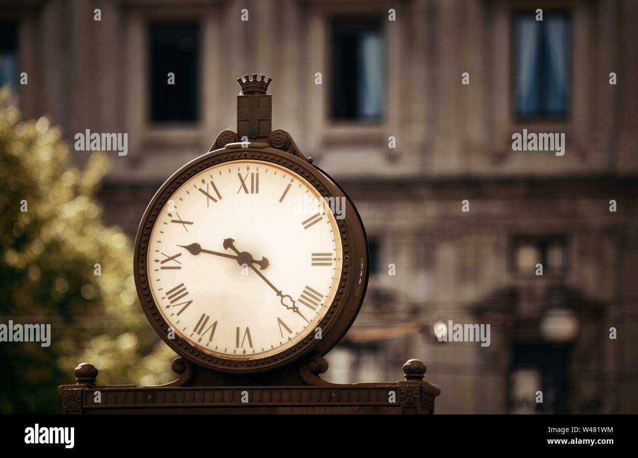 Vintage clock in Milan street Italy Stock Photo - Alamy