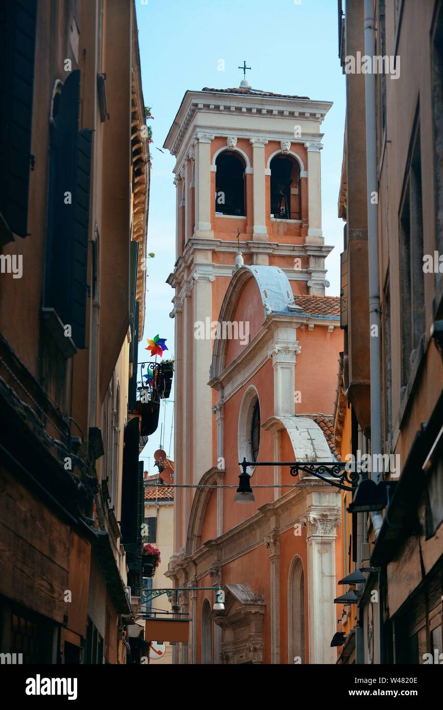 Alley view with bell tower and historical buildings in Venice, Italy ...