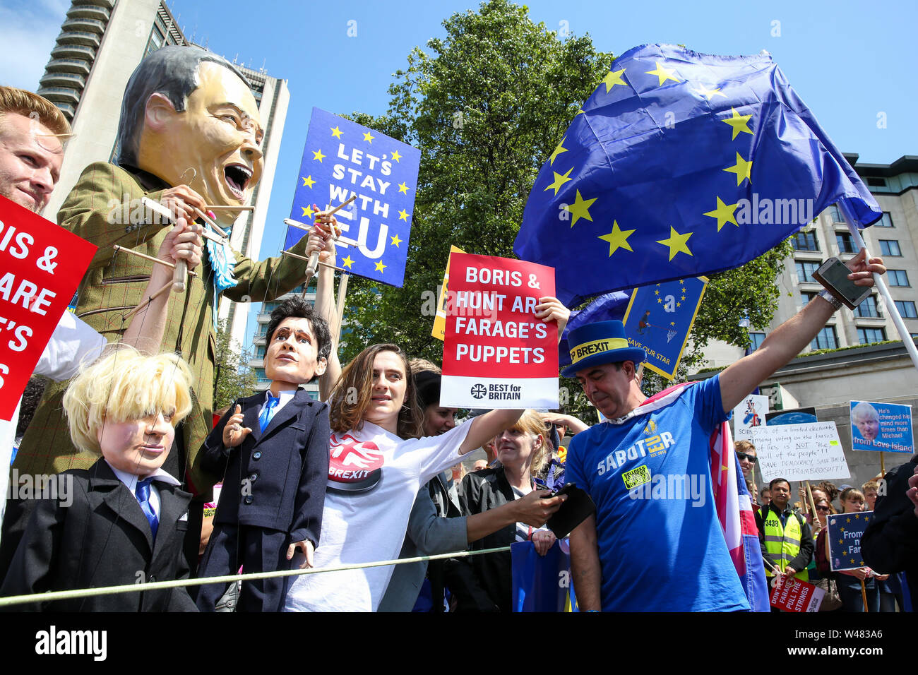 Pro EU demonstrators hold placards while waving an EU flag, during the ...