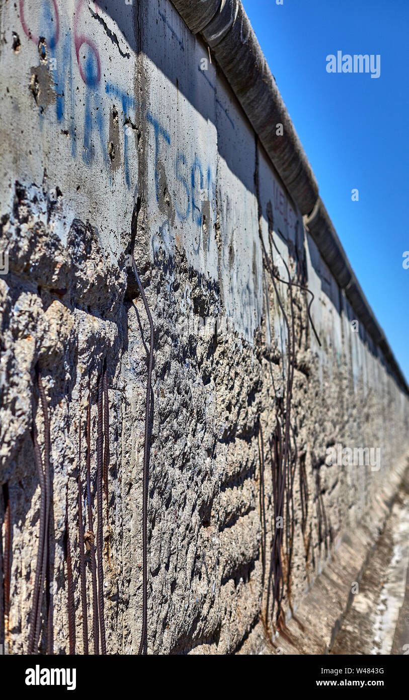 The Berlin Wall was a guarded concrete barrier that physically and ...