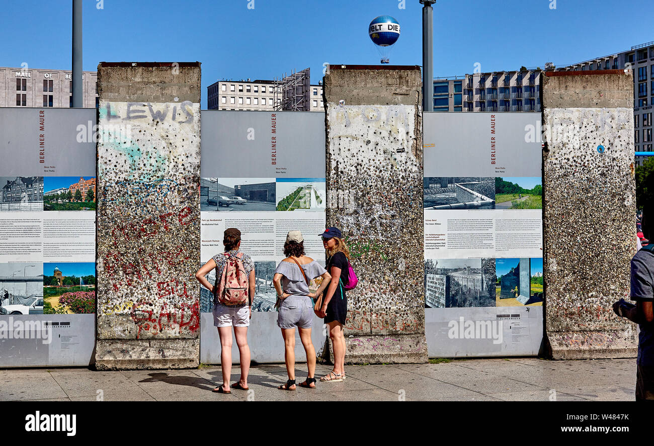 The Berlin Wall was a guarded concrete barrier that physically and ...