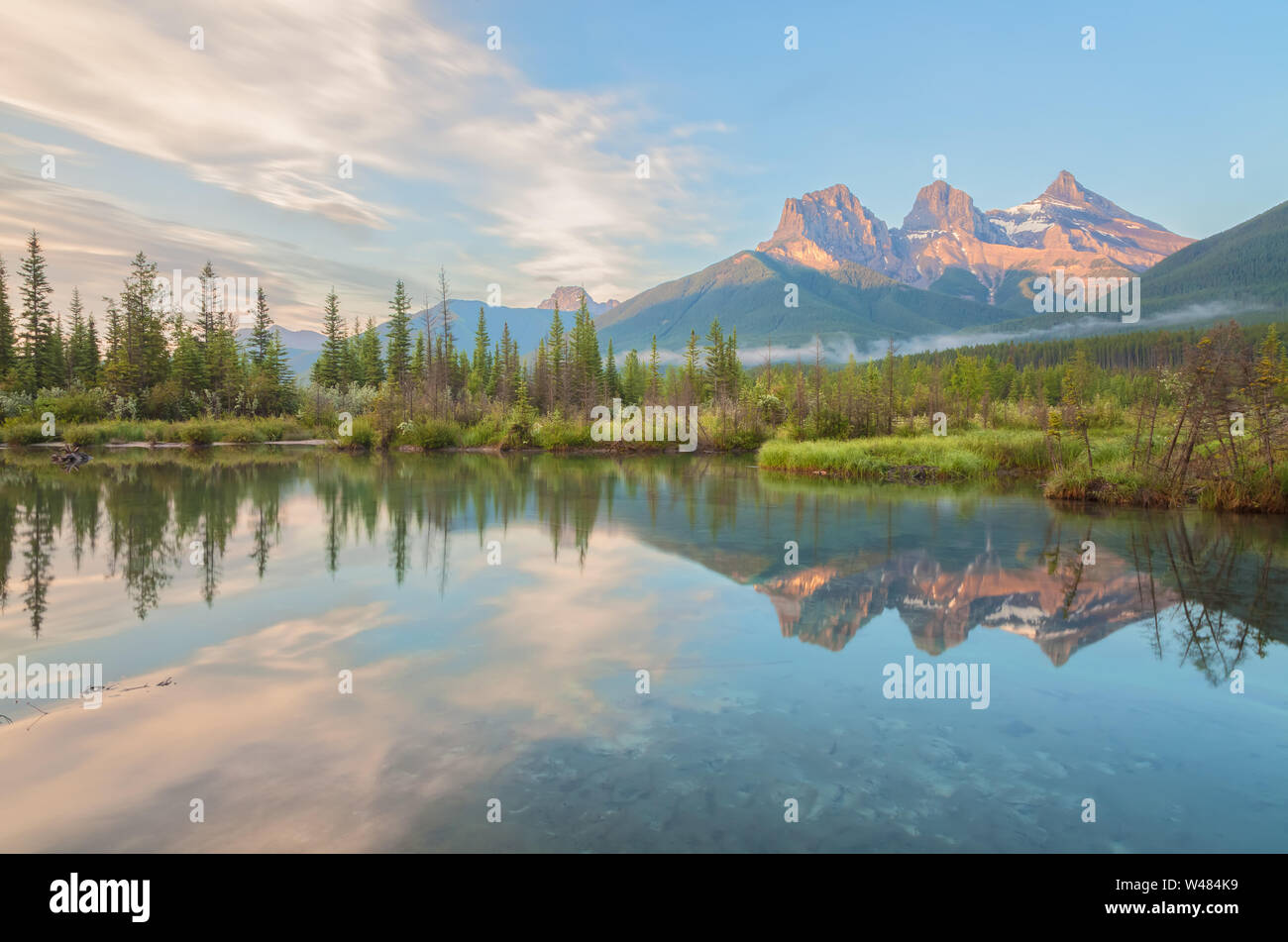 The Three Sisters Mountain Peaks and their reflections at sunrise ...